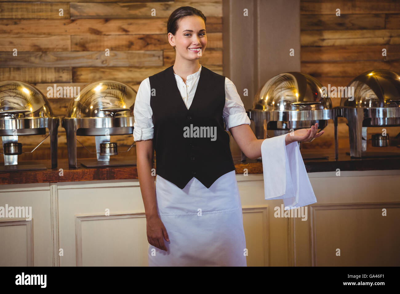 Smiling waitress standing Stock Photo - Alamy