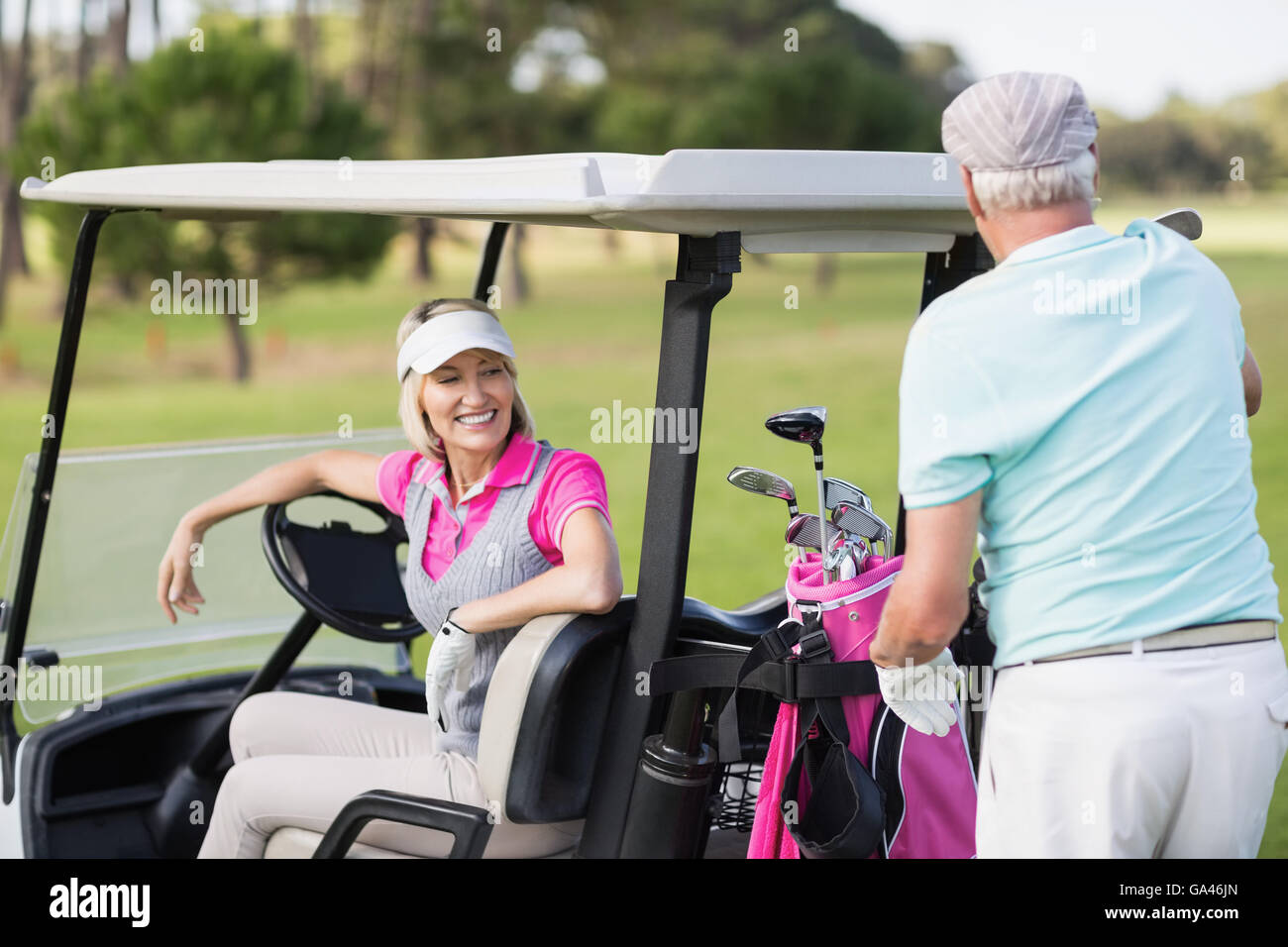 Smiling golfer couple Stock Photo - Alamy