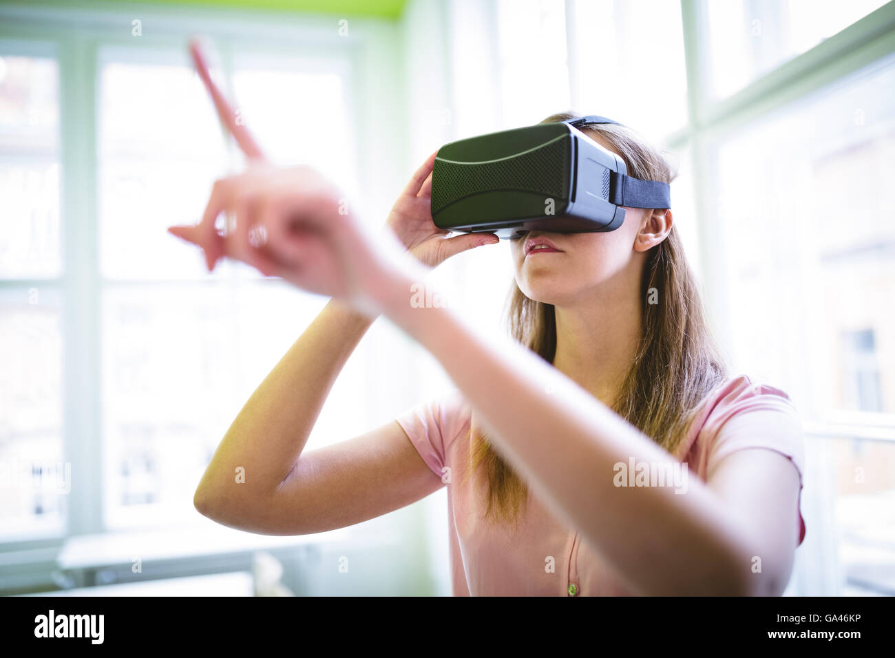 Graphic designer gesturing while using virtual reality headset Stock ...