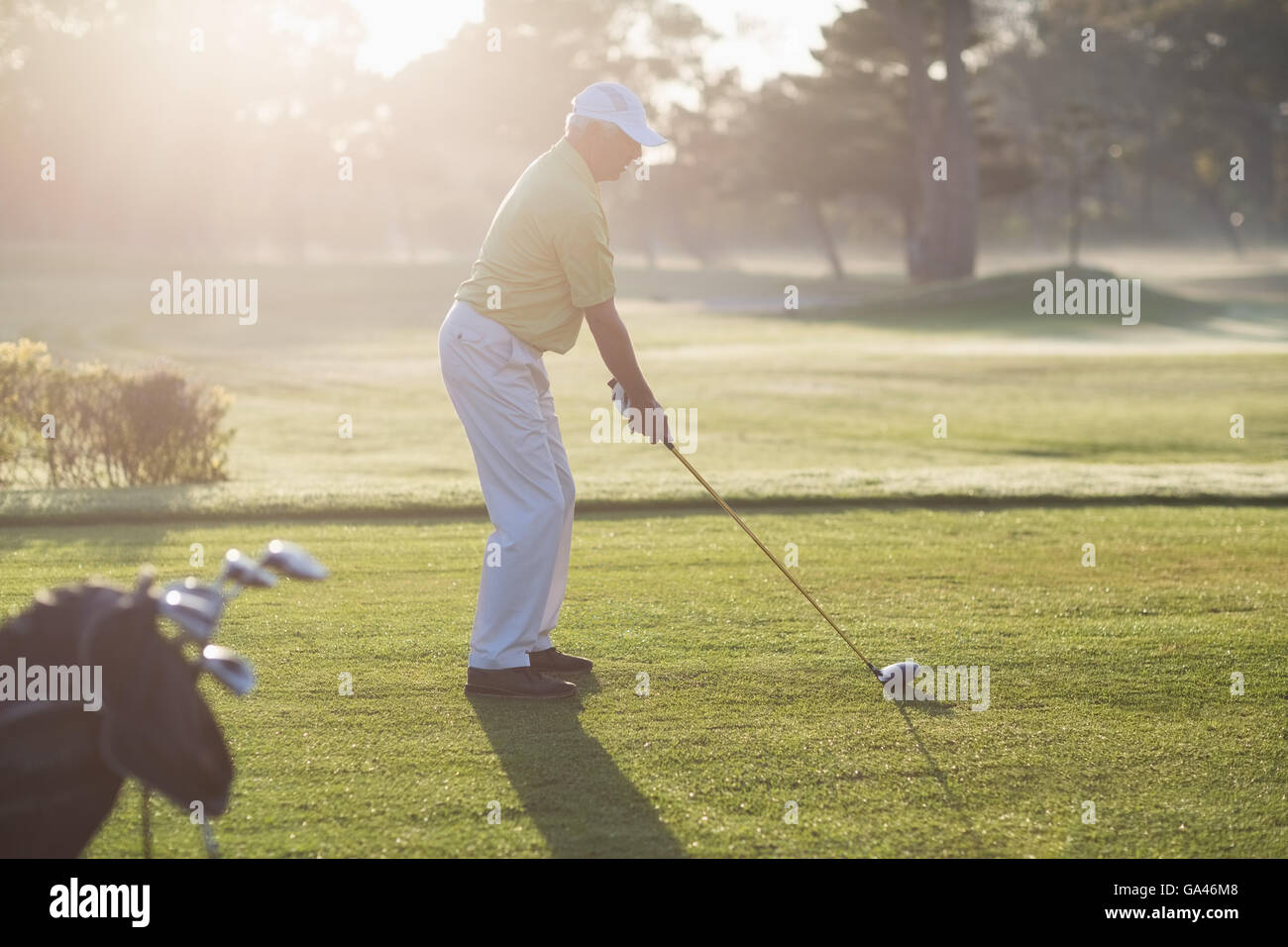 Side view of man playing golf Stock Photo - Alamy