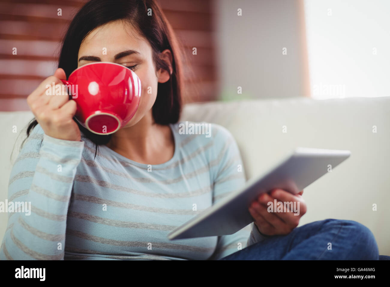 Woman drinking coffee at home Stock Photo - Alamy