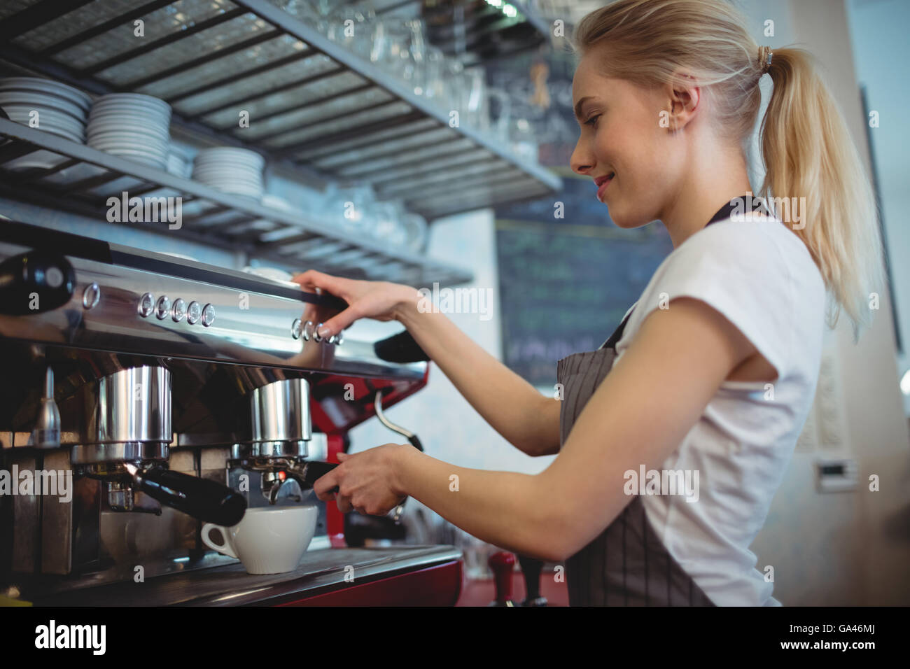 Side view of waitress using coffee maker at cafe Stock Photo - Alamy