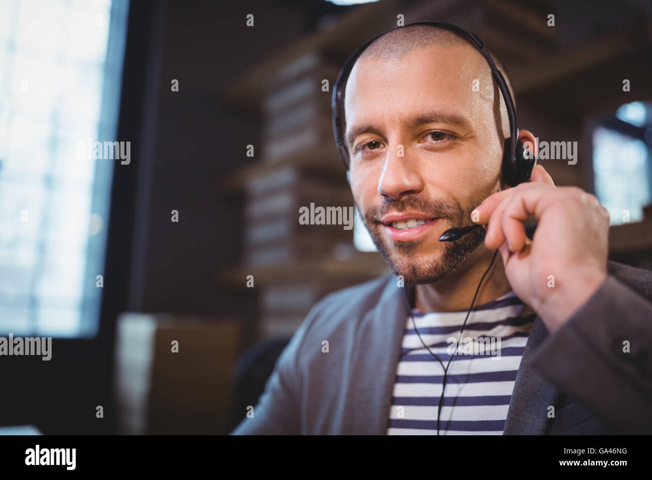 Creative businessman using headphones in office Stock Photo - Alamy