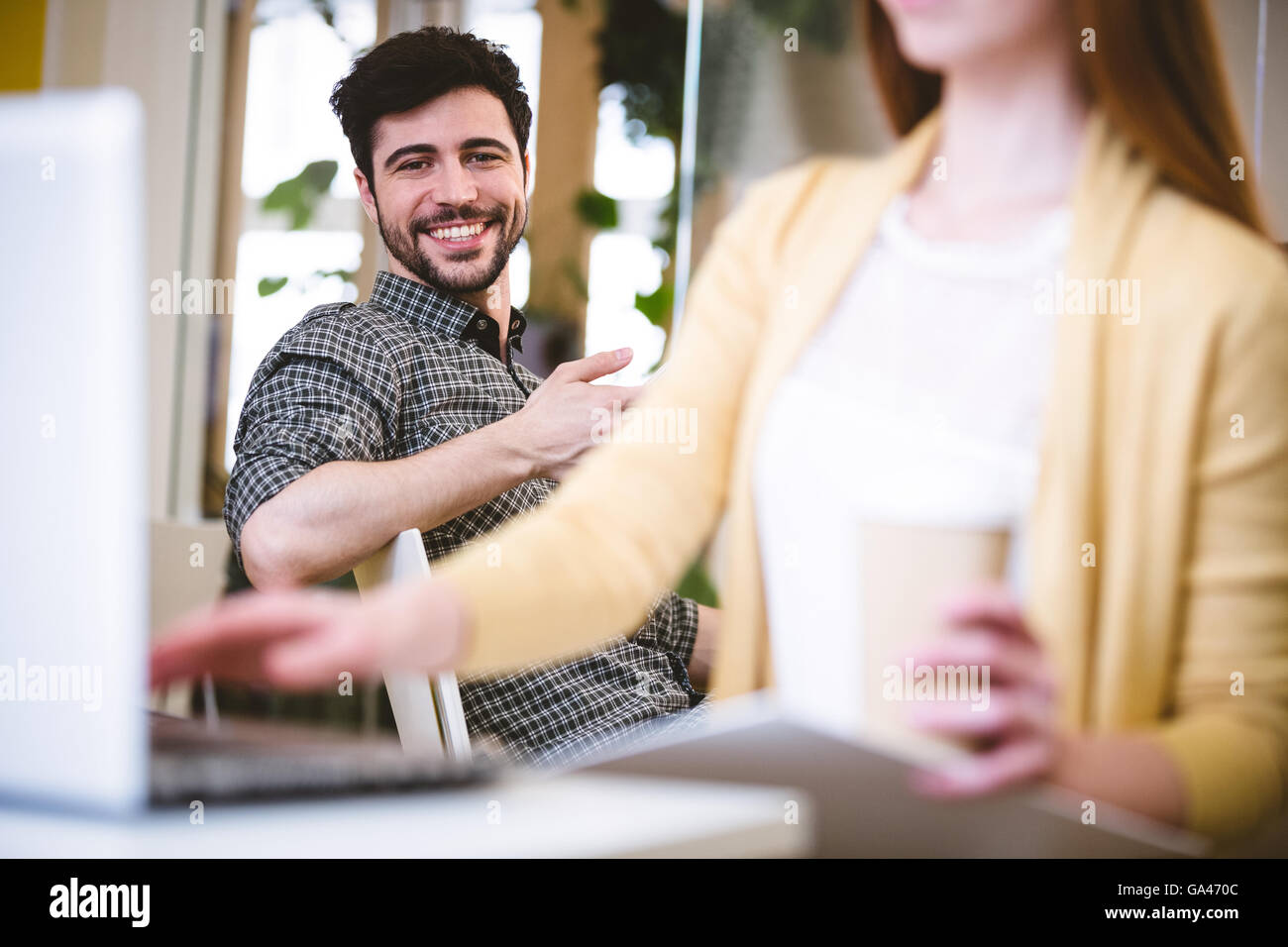 Smiling businessman with female coworker Stock Photo - Alamy