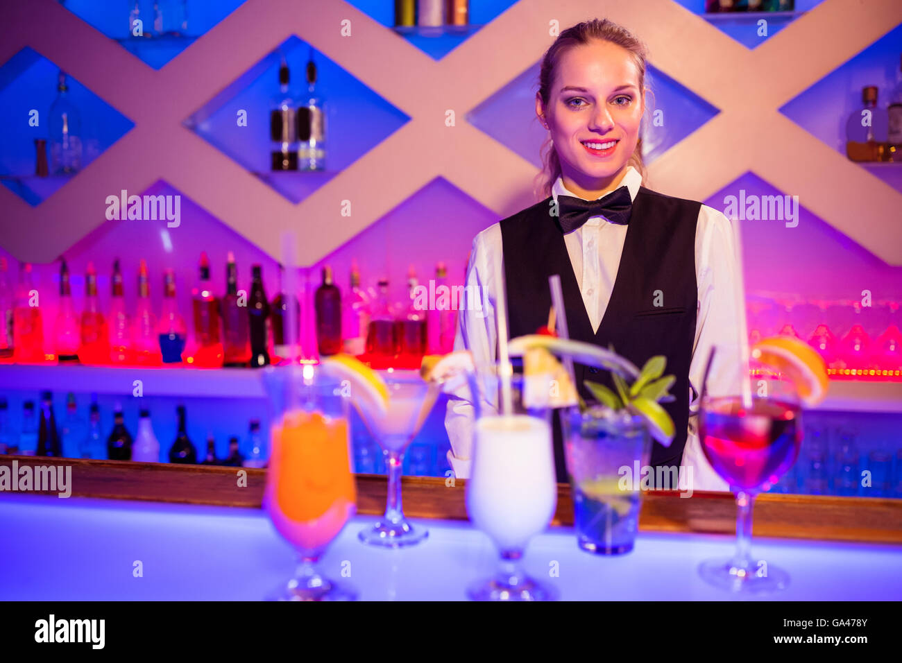 Portrait of smiling barmaid standing Stock Photo - Alamy