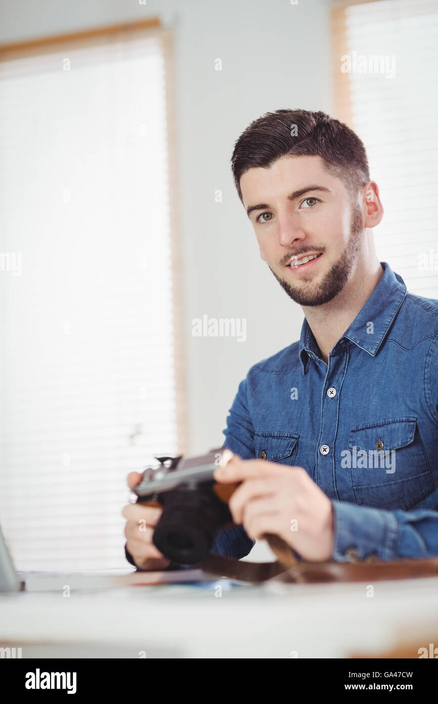 Portrait of man holding camera Stock Photo - Alamy