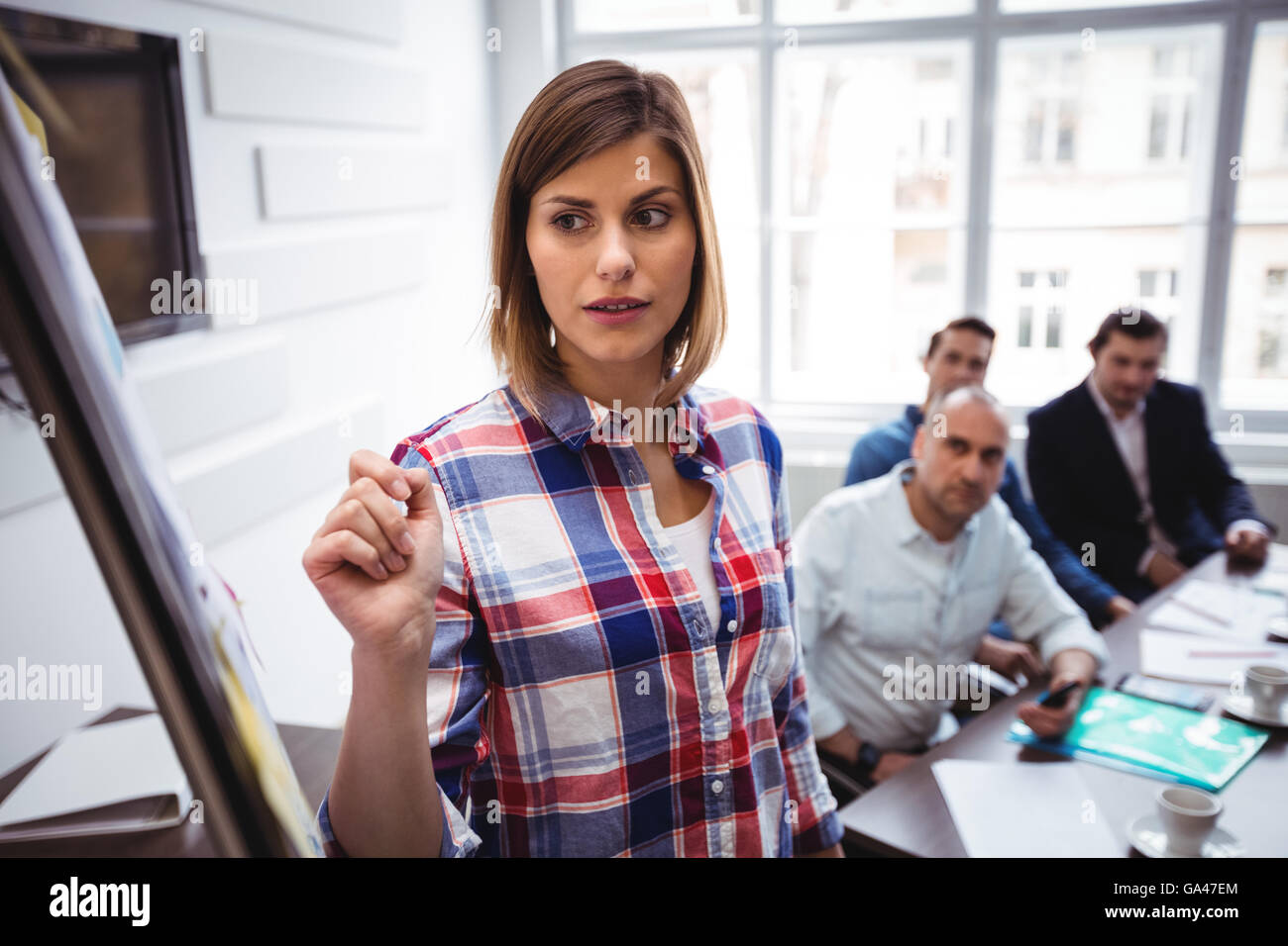Confused businesswoman giving presentation Stock Photo - Alamy