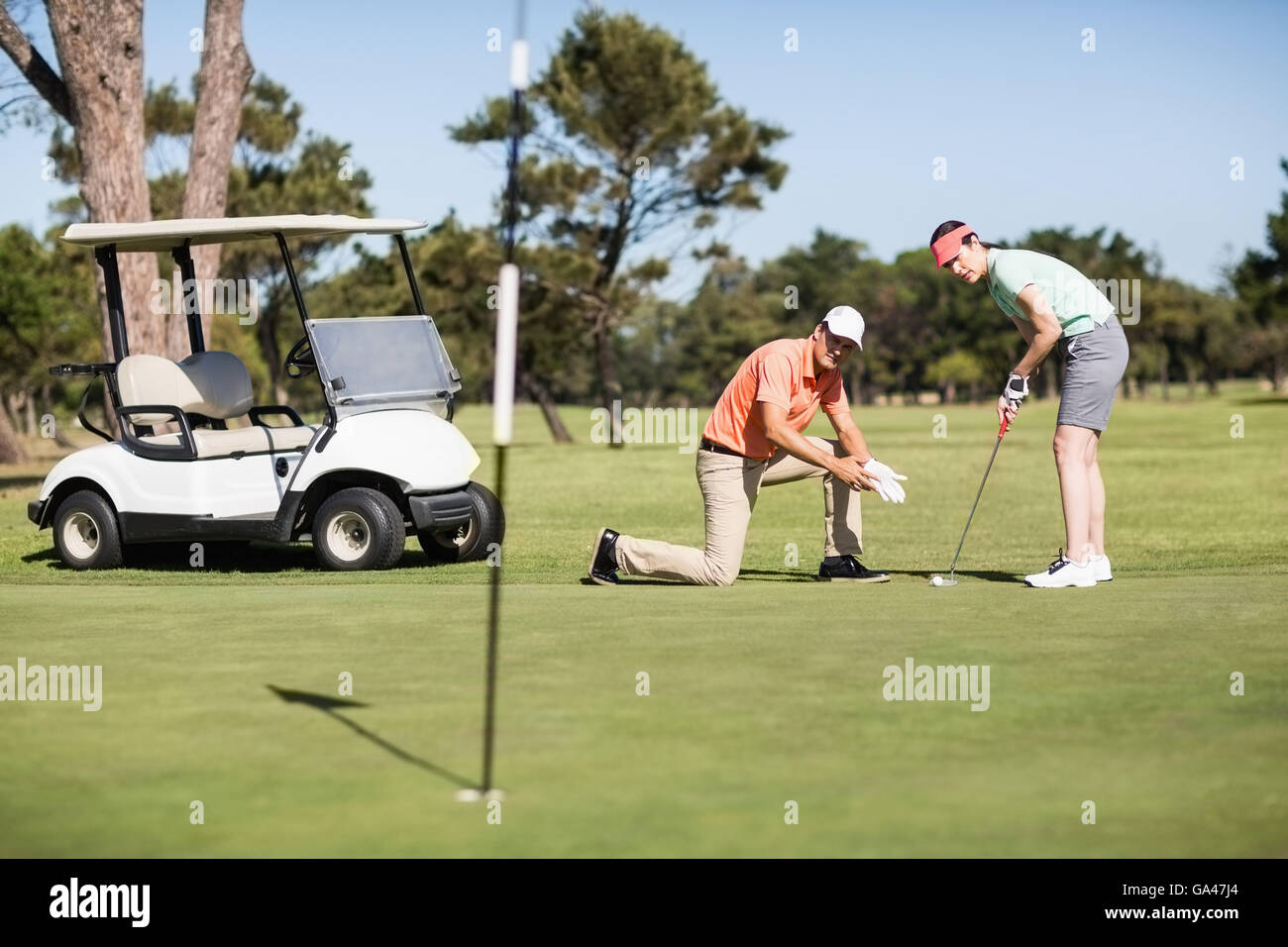 Couple playing golf together Stock Photo - Alamy