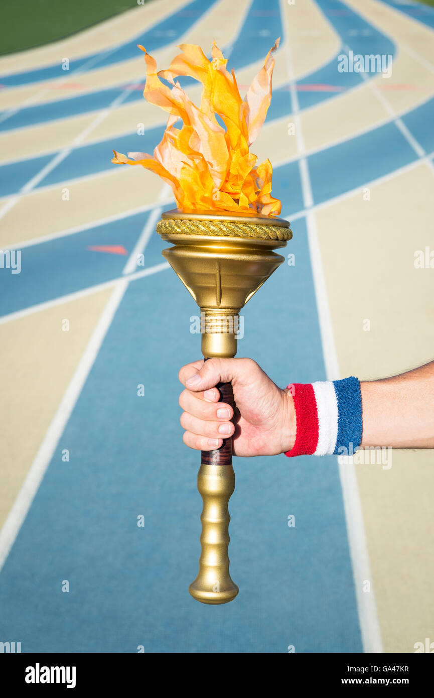 Hand of an American athlete wearing USA colors wristband holding sport ...