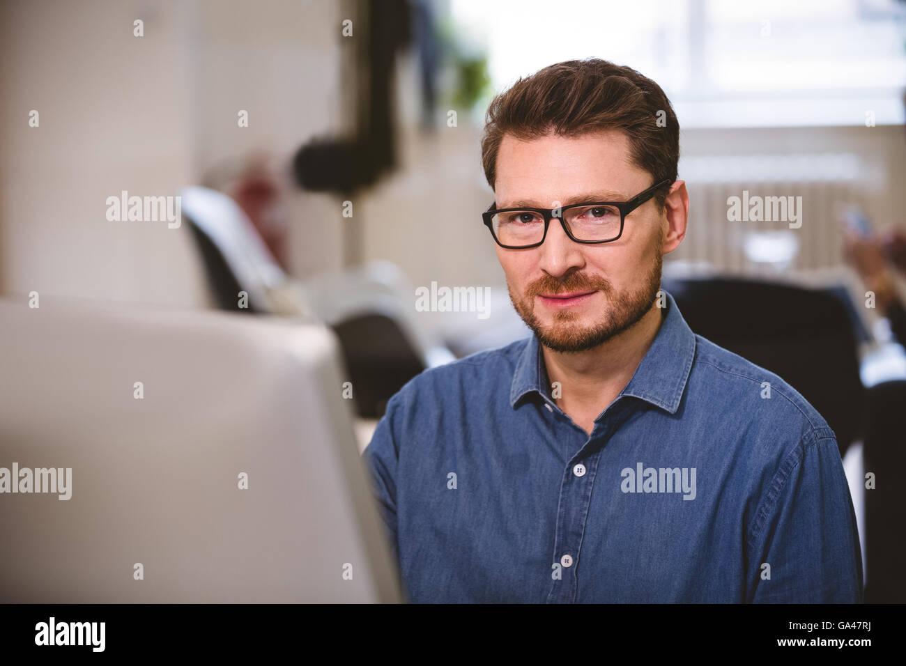 Portrait of confident executive with computer at office Stock Photo - Alamy