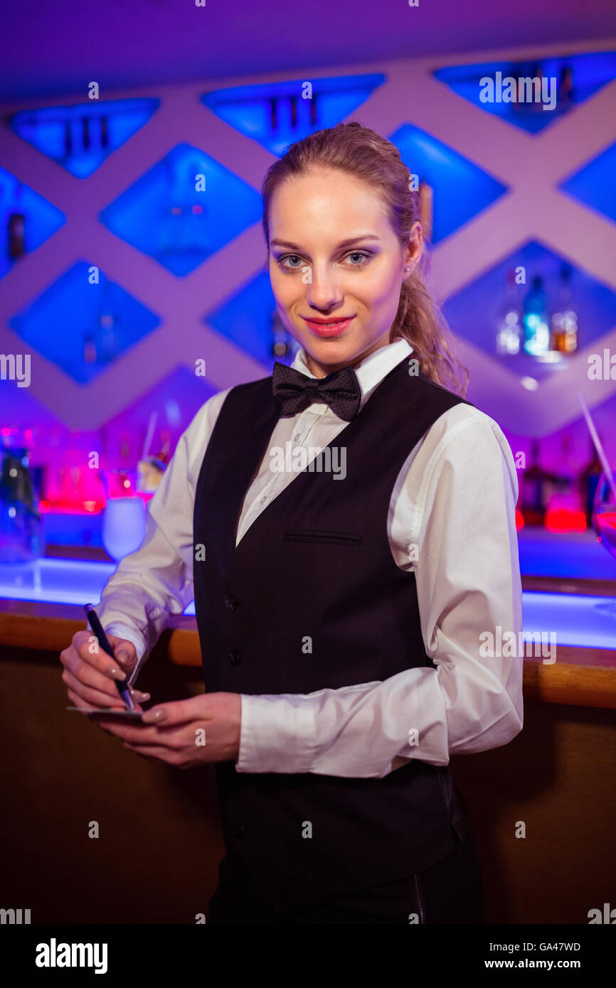 Confident young barmaid at counter Stock Photo - Alamy