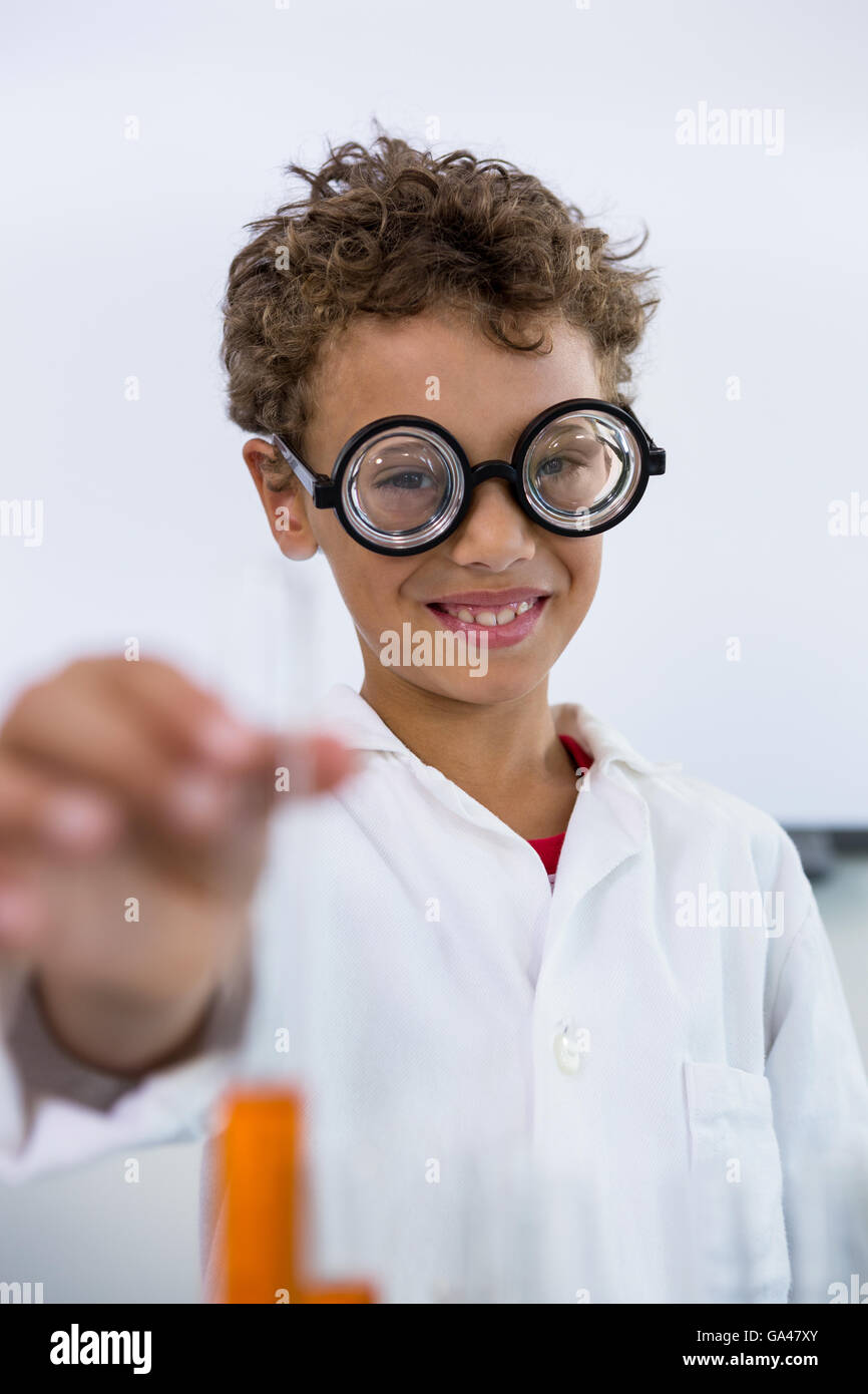 Boy showing test tube with liquid at laboratory Stock Photo - Alamy