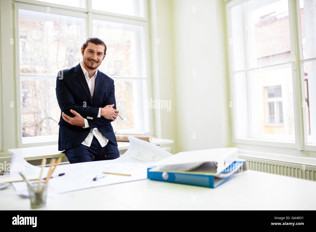 Smiling architect with arms crossed Stock Photo - Alamy