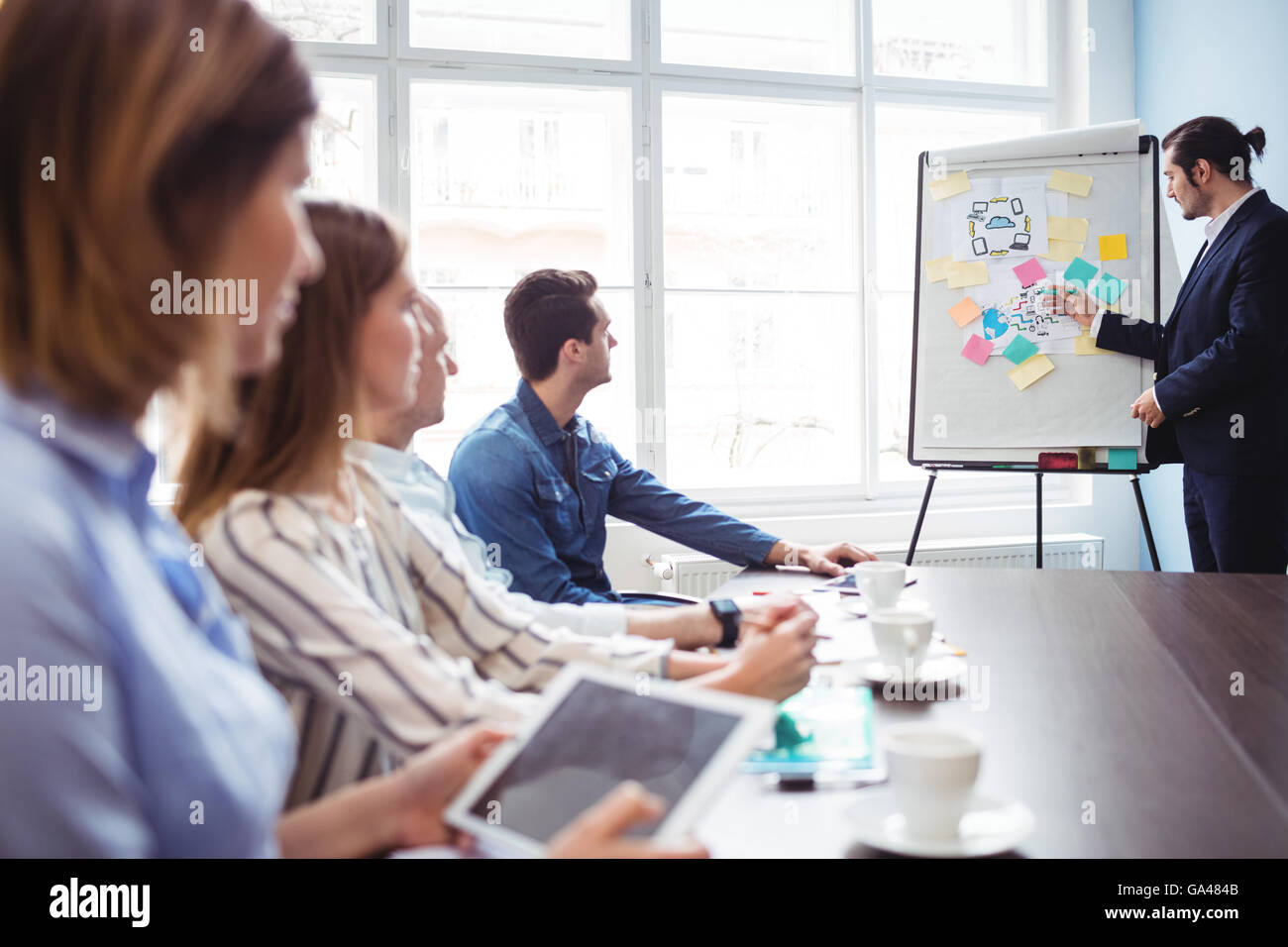 Businessman giving presentation in office Stock Photo - Alamy