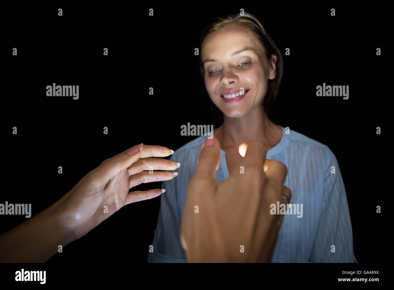 Cropped image of hypnotist hypnotizing woman Stock Photo - Alamy