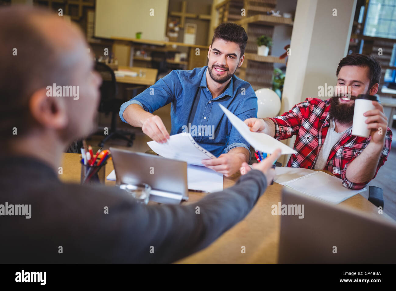 Business people giving documents to colleague Stock Photo - Alamy