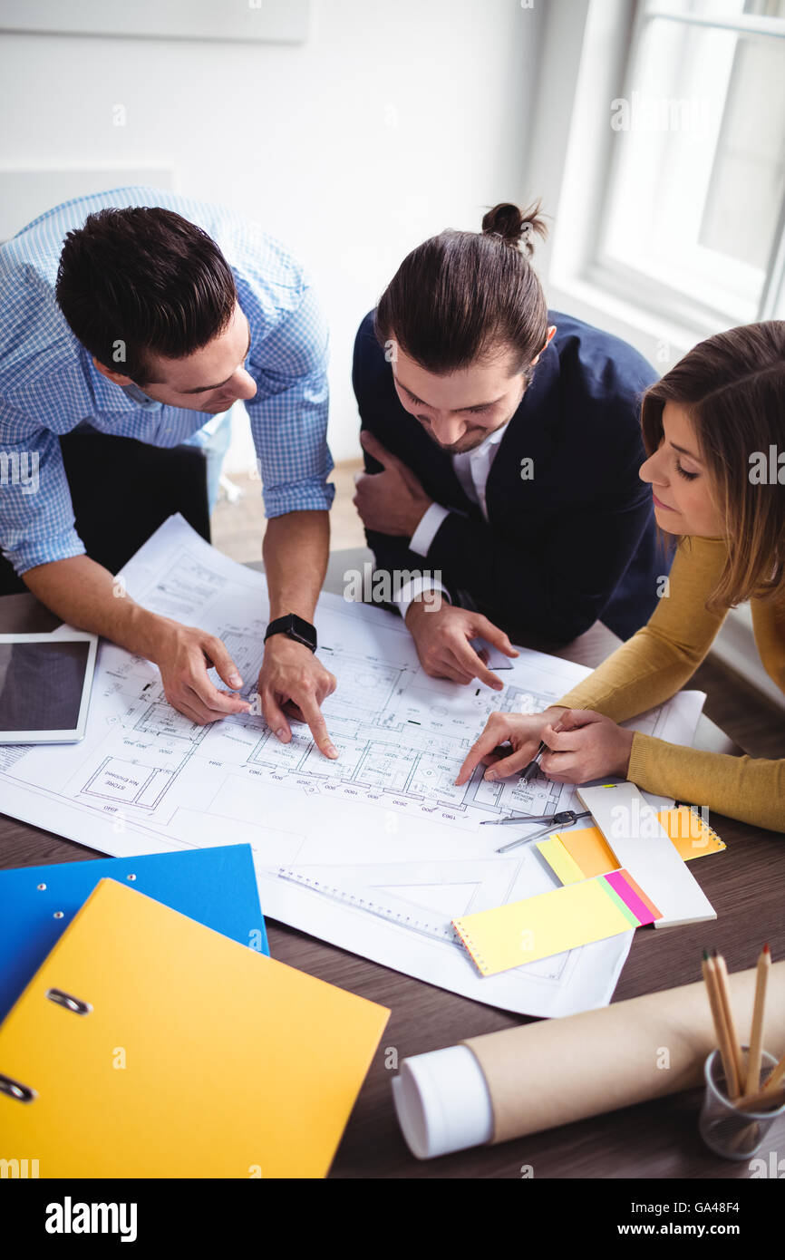 Business people discussing on blueprint Stock Photo - Alamy