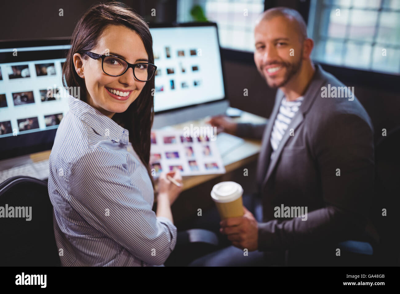 Colleagues looking computer screen in hi-res stock photography and ...