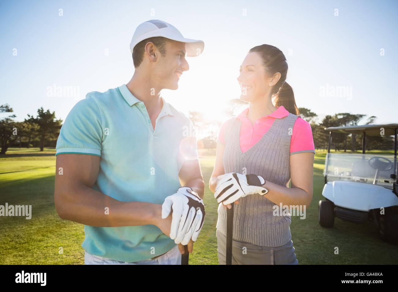 Cheerful golf player couple Stock Photo - Alamy