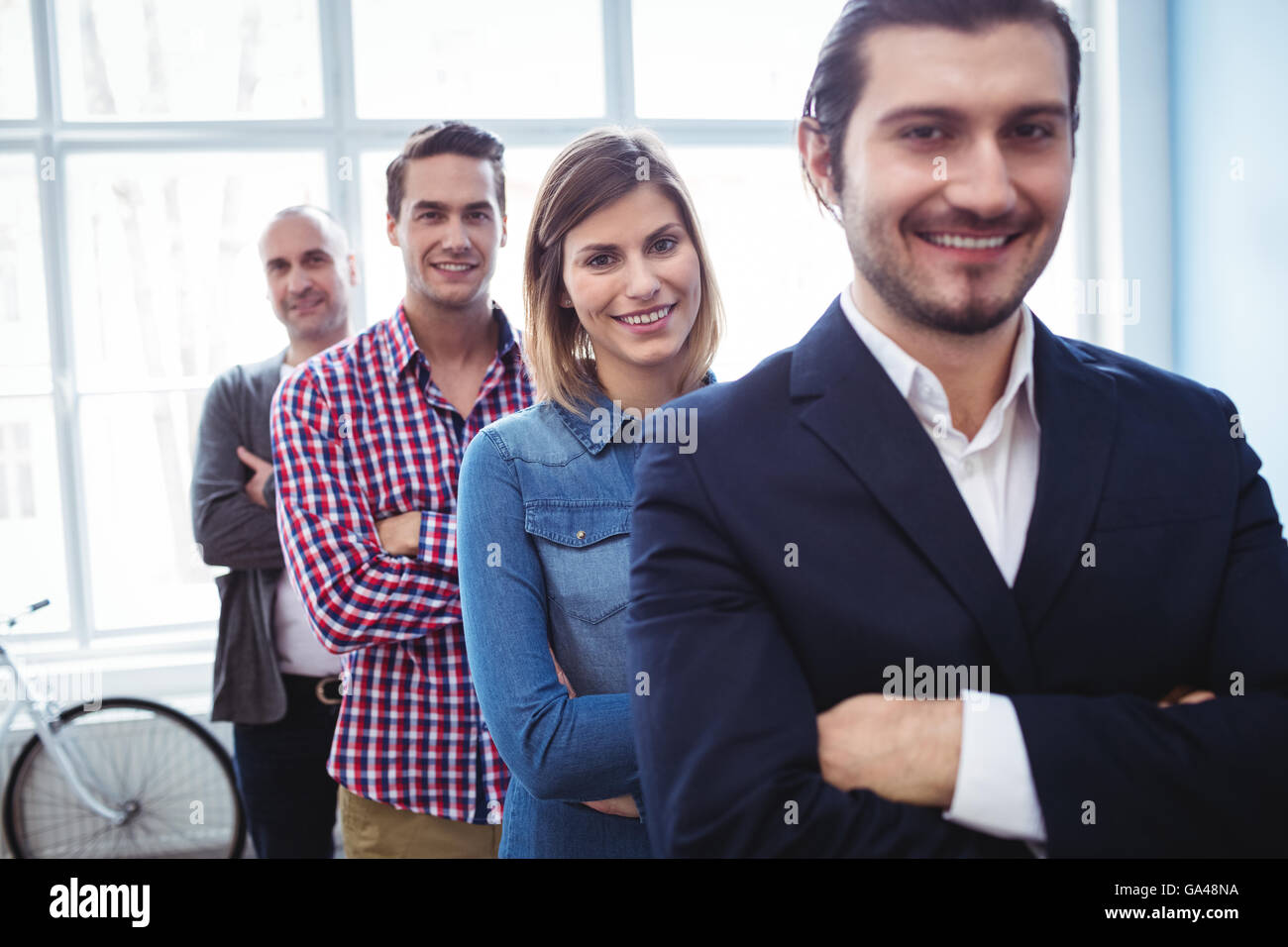 Smiling business people standing in row Stock Photo - Alamy