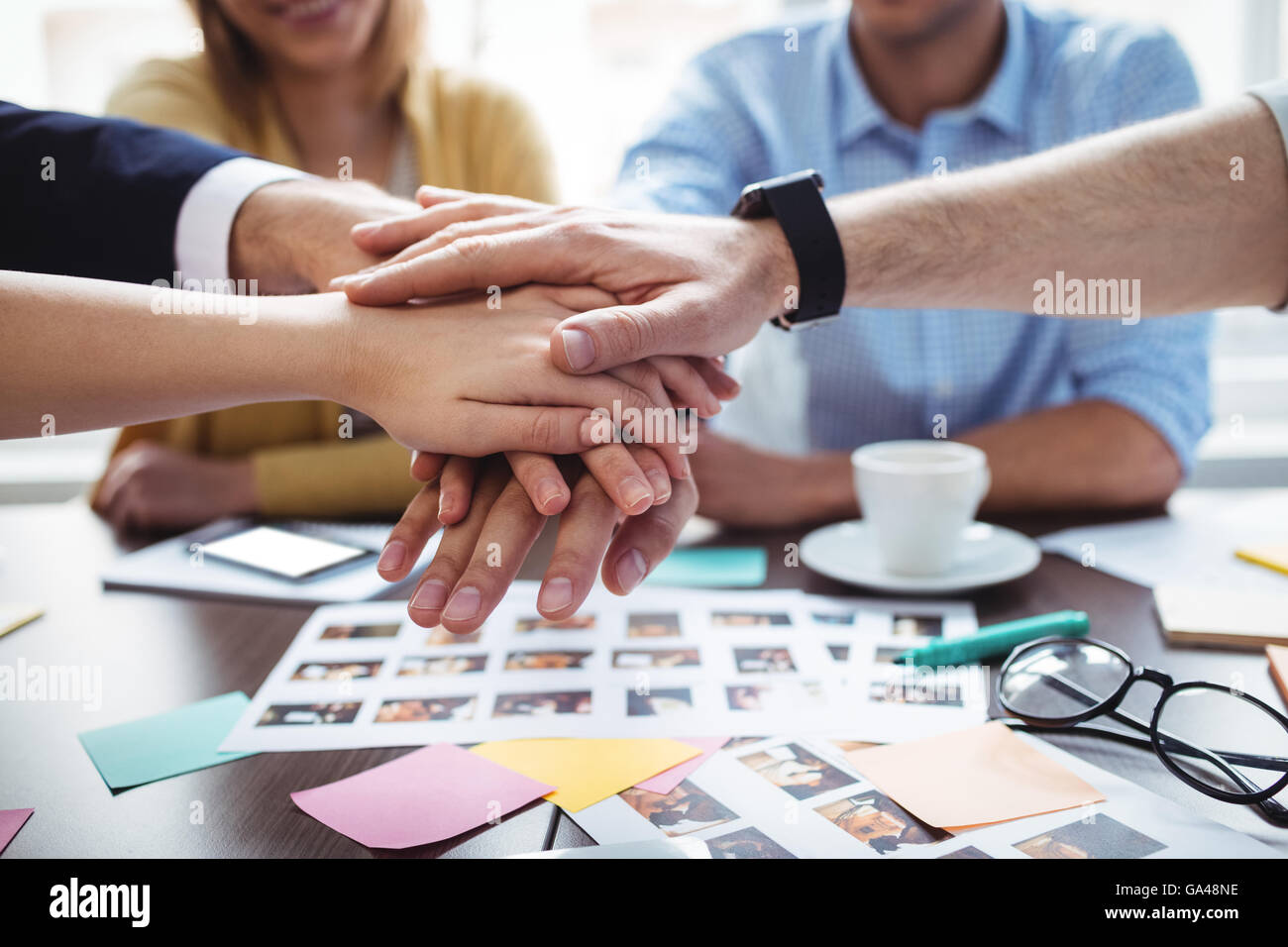 Colleagues hand stacking in meeting room Stock Photo - Alamy