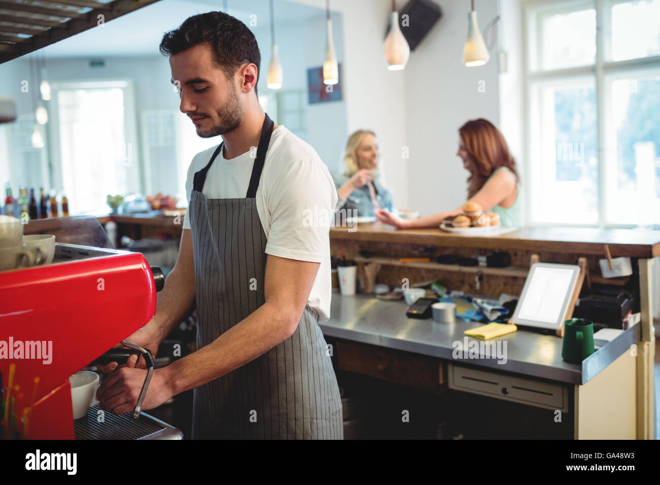 Confident barista using espresso maker at coffee shop Stock Photo - Alamy