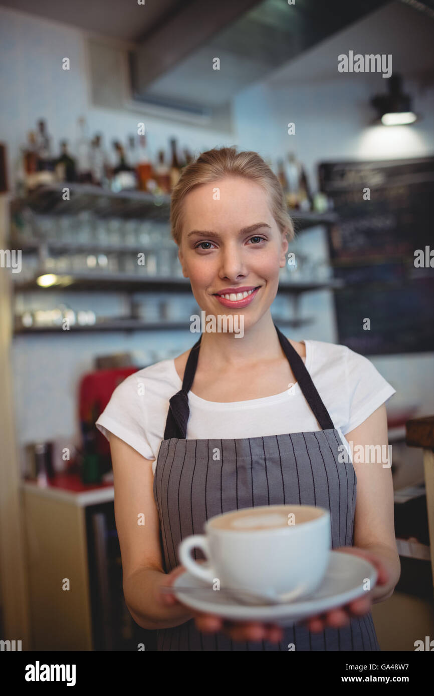 Portrait of confident waitress serving coffee at shop Stock Photo - Alamy