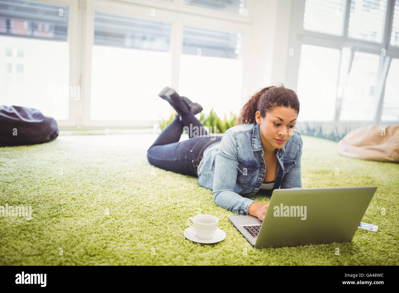 Using laptop lying down hi-res stock photography and images - Alamy