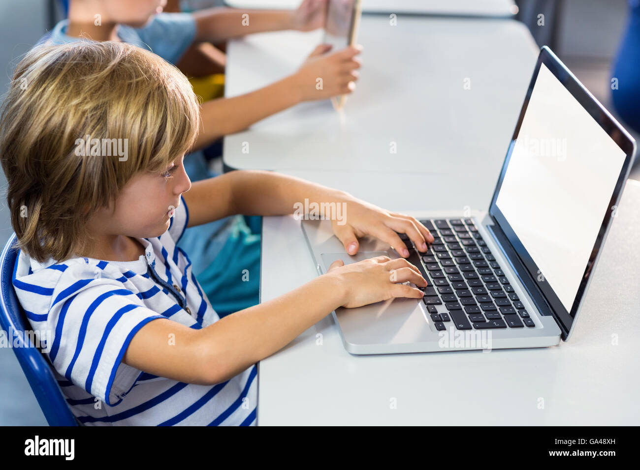 Boy using laptop Stock Photo - Alamy
