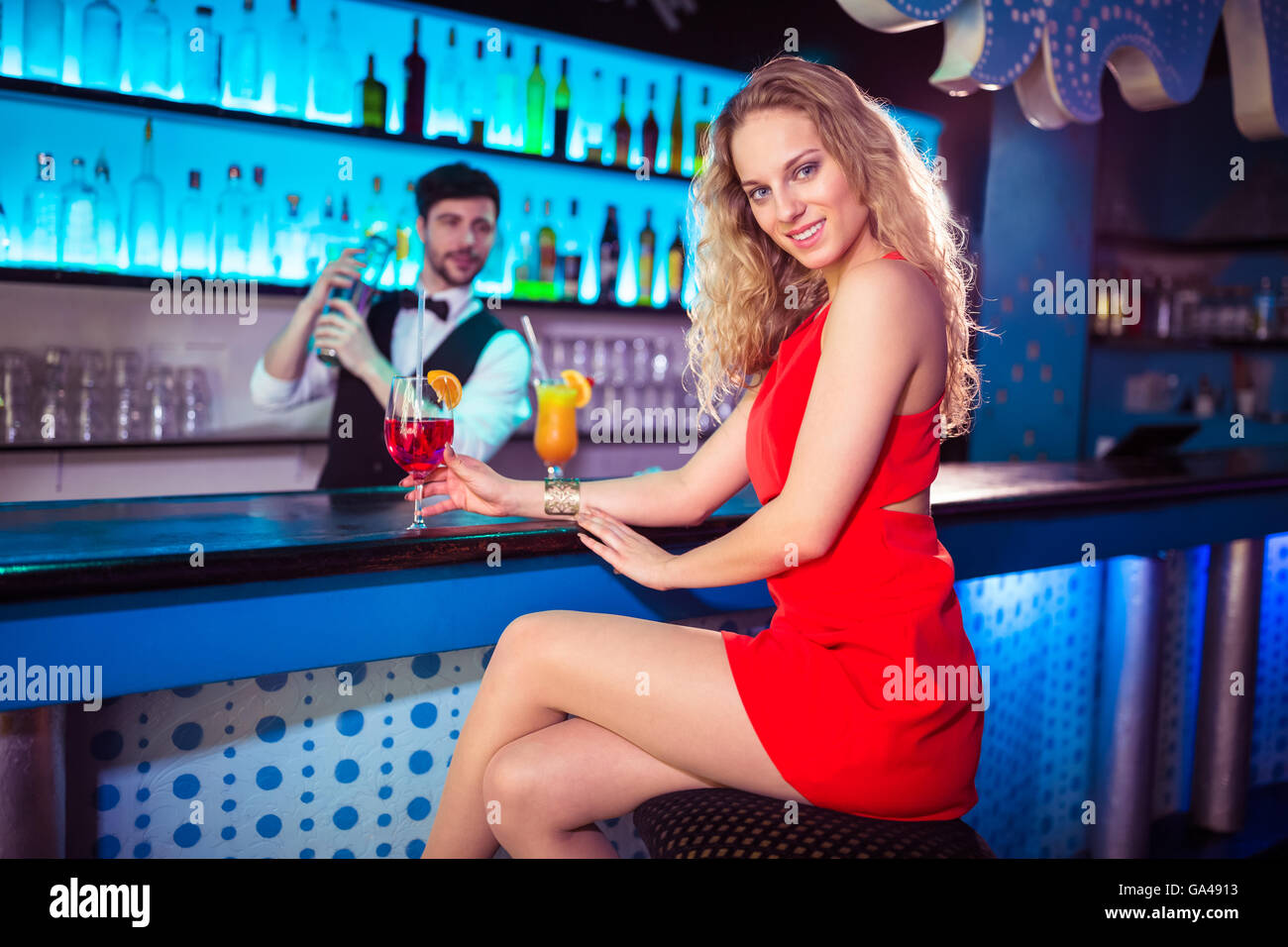 Young woman sitting at bar hi-res stock photography and images - Alamy