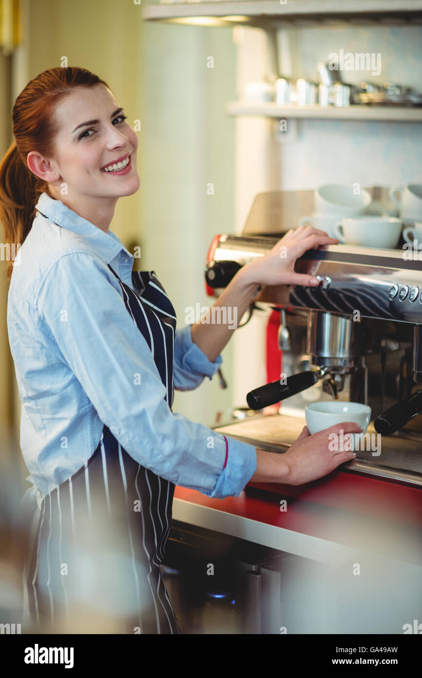 Portrait of happy waitress using espresso machine Stock Photo - Alamy