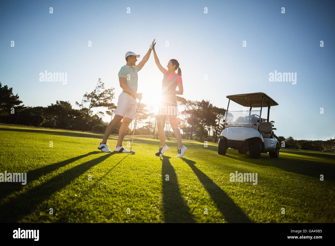 Young couple playing golf hi-res stock photography and images - Alamy