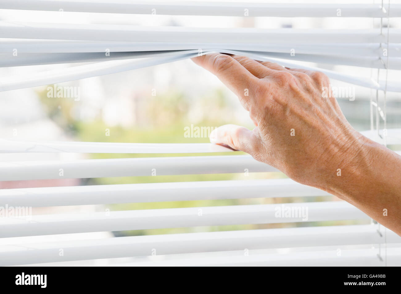 Person hand on blinds Stock Photo - Alamy
