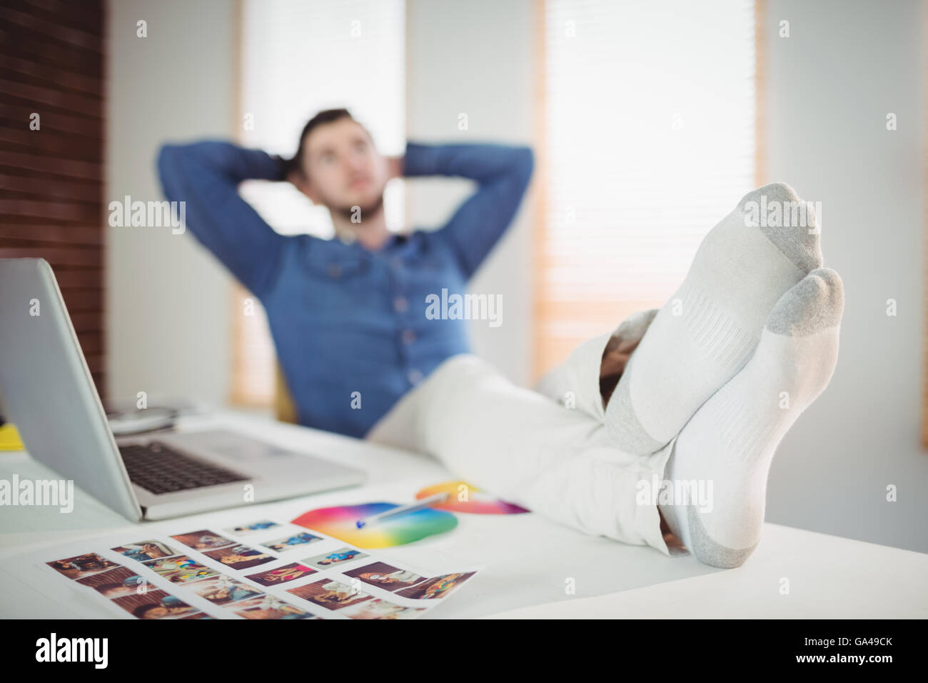 Man relaxing in office Stock Photo - Alamy