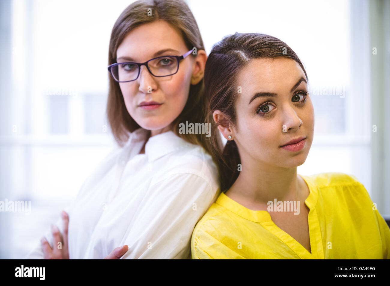 Portrait of confident executives standing at creative office Stock ...