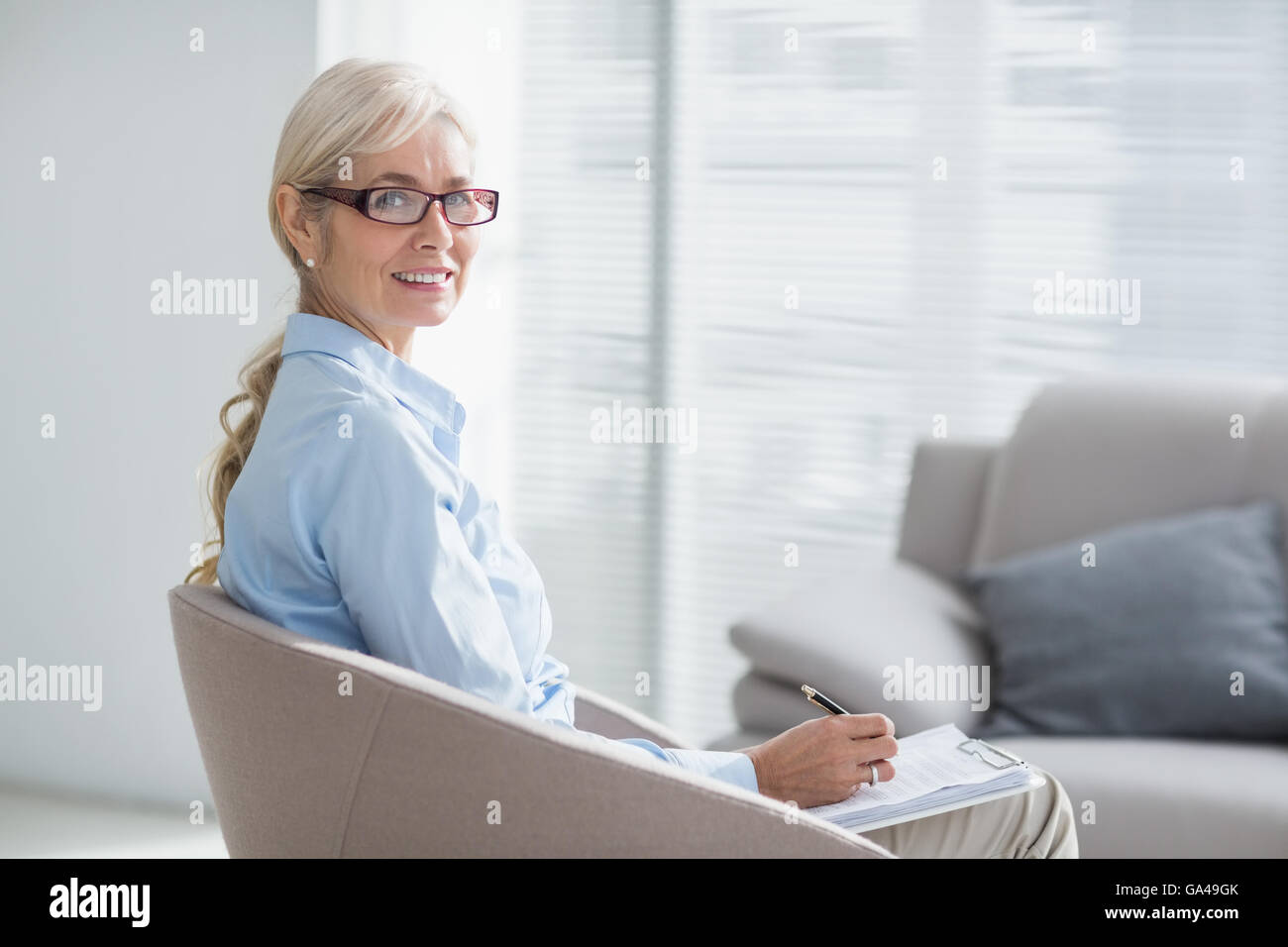 Portrait of smiling therapist Stock Photo - Alamy