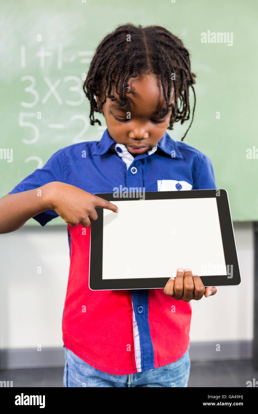 Boy using digital tablet in classroom Stock Photo - Alamy