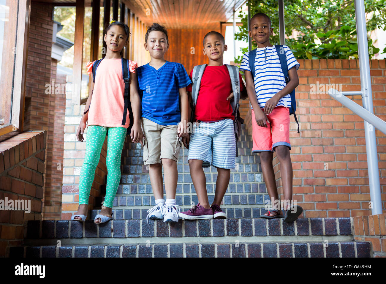Low angle portrait of classmates standing on staircase Stock Photo - Alamy