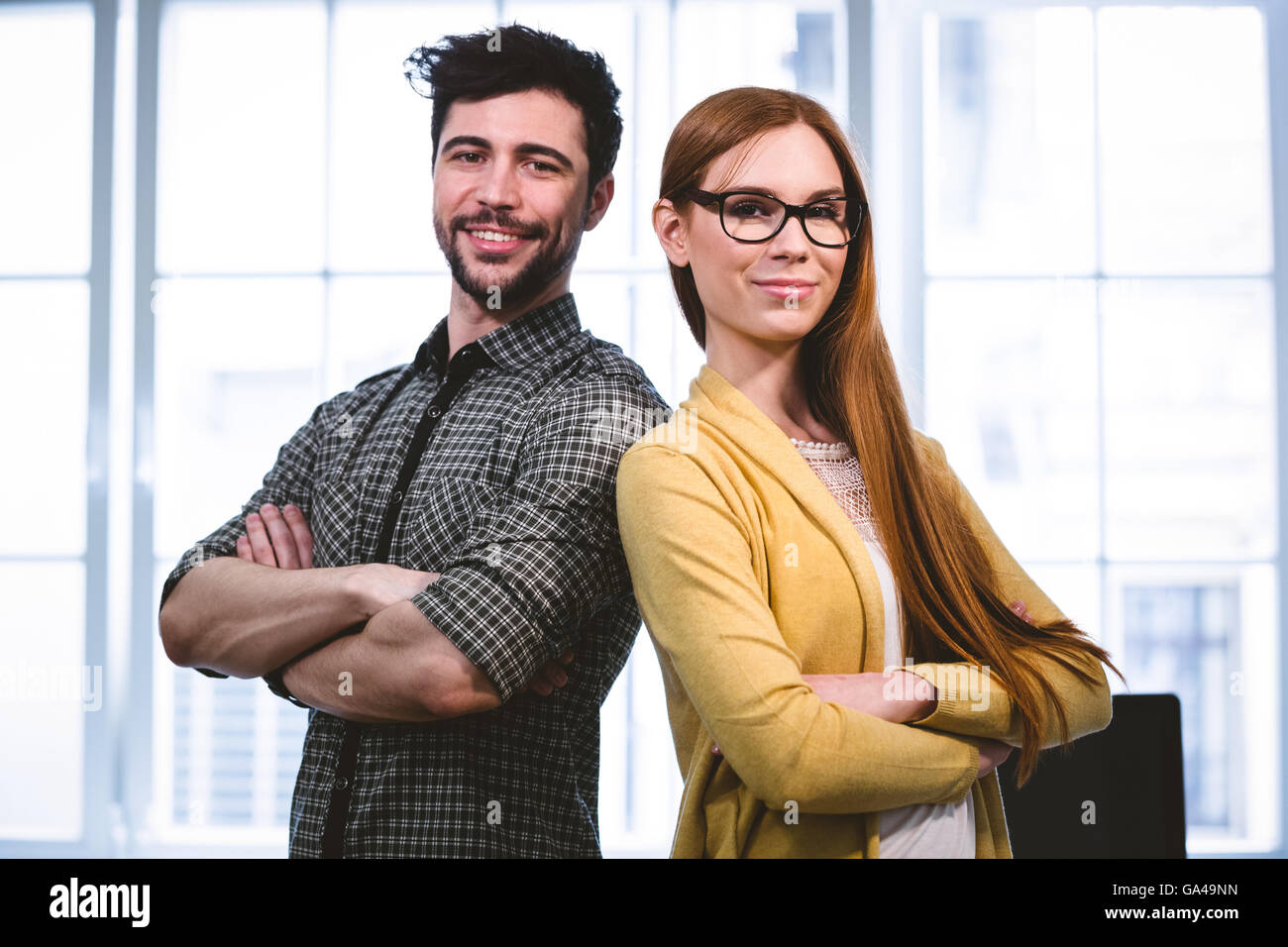 Smart business people standing with arms crossed Stock Photo - Alamy
