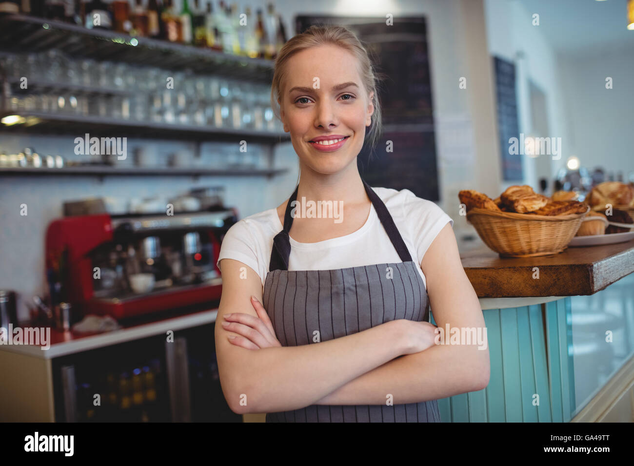 Portrait of happy waitress with arms crossed at cafe Stock Photo - Alamy