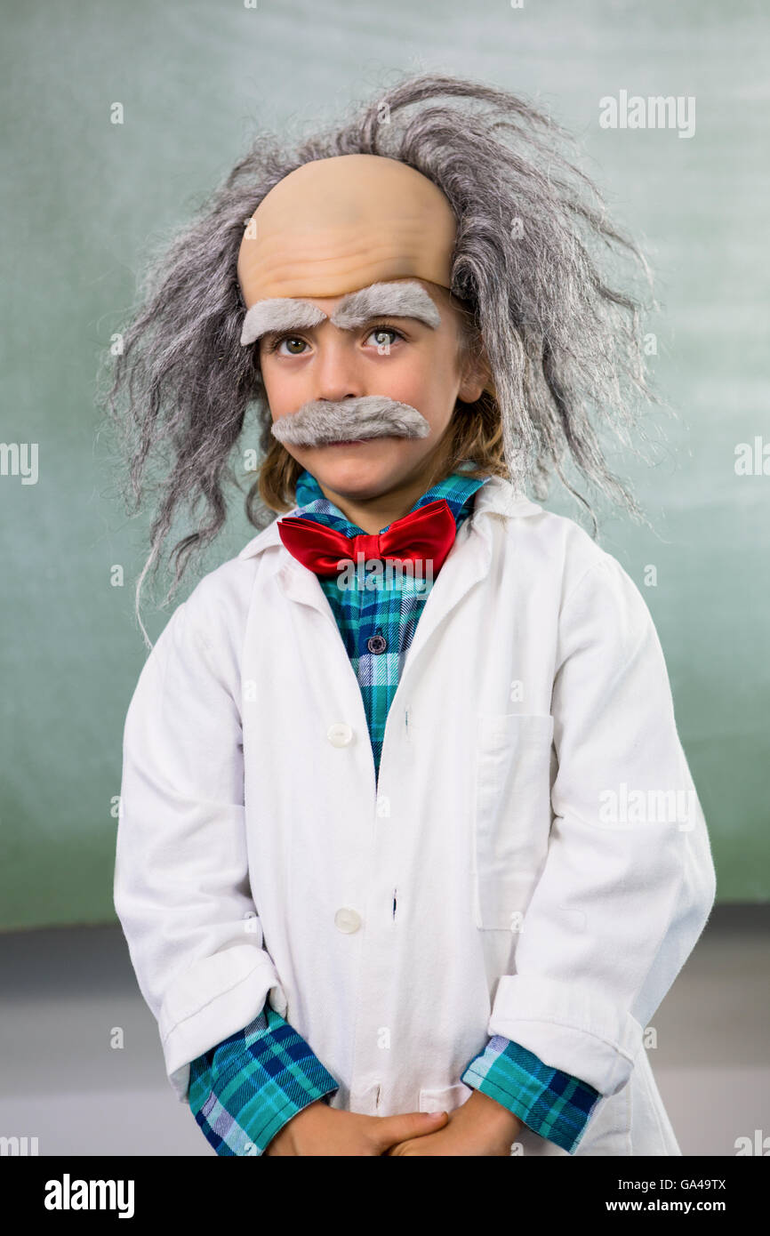 Portrait of boy dressed as scientist standing against board Stock Photo ...