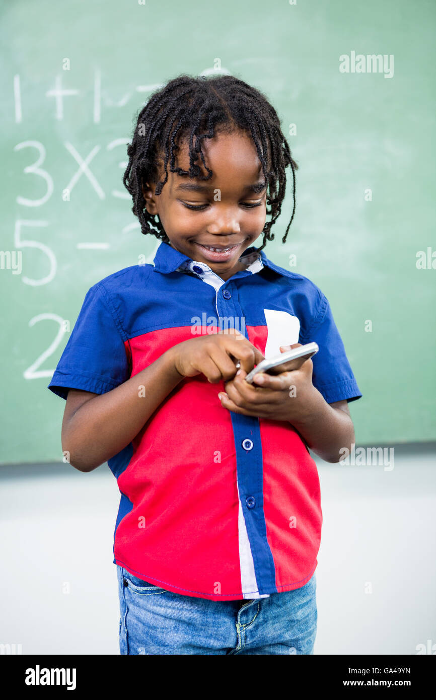 Boy using mobile phone in classroom Stock Photo - Alamy