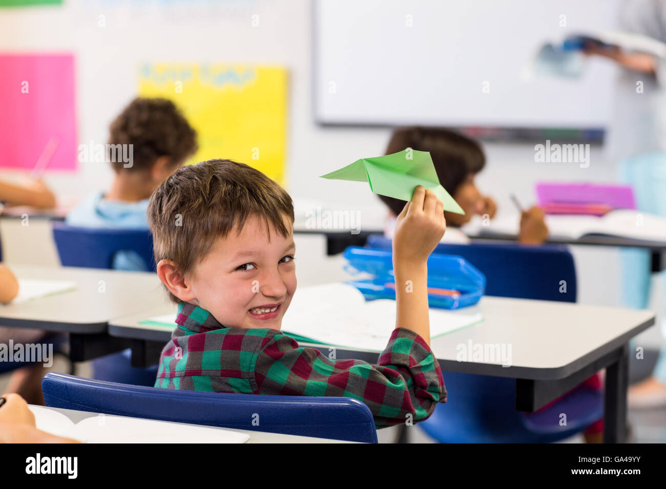 Cute boy holding paper airplane Stock Photo - Alamy