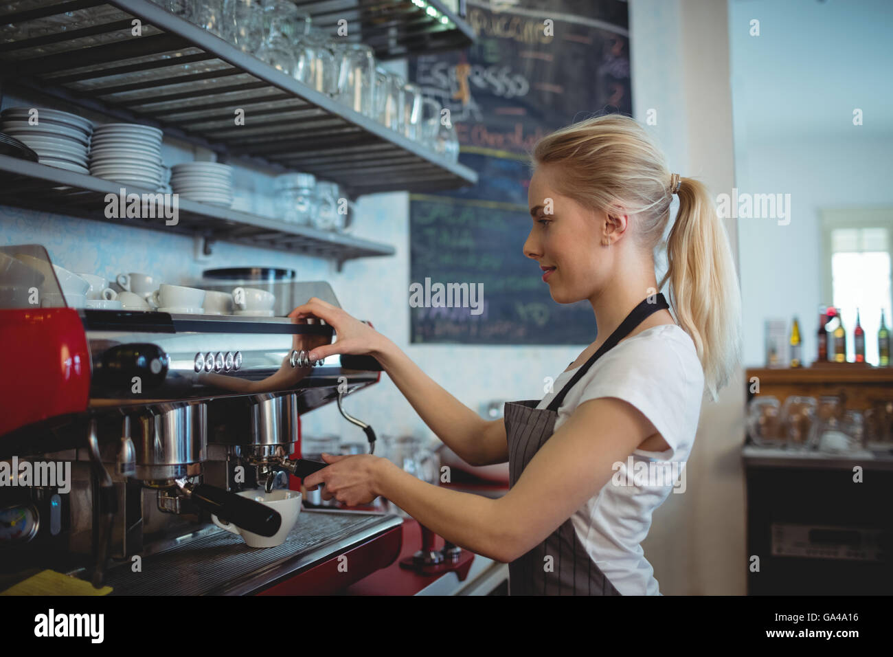 Side view of barista using espresso maker at coffee house Stock Photo ...