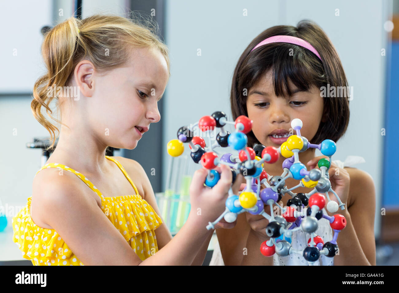Girls holding DNA model Stock Photo - Alamy