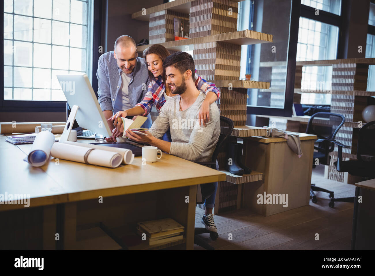 Business people discussing over document at computer desk Stock Photo ...