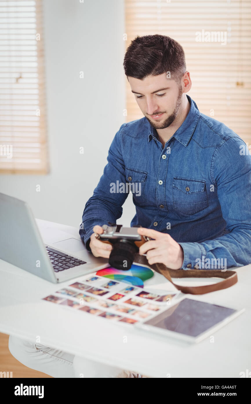 Photographer checking photos in camera Stock Photo - Alamy