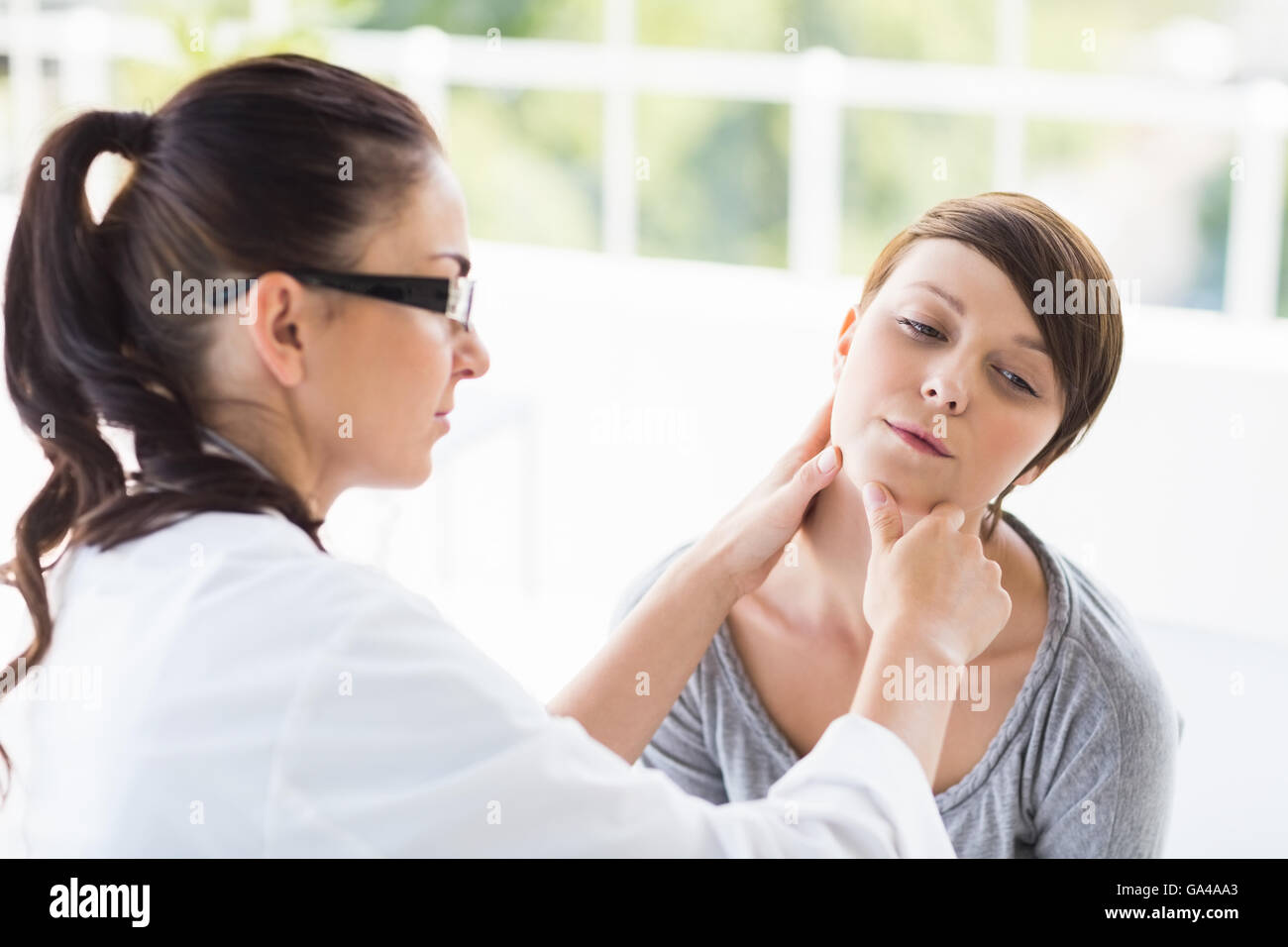 Doctor checking patient Stock Photo - Alamy