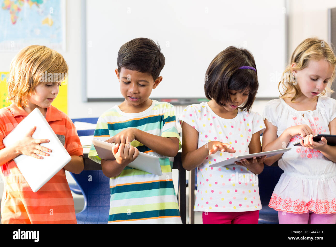 School kids using digital tablets Stock Photo - Alamy