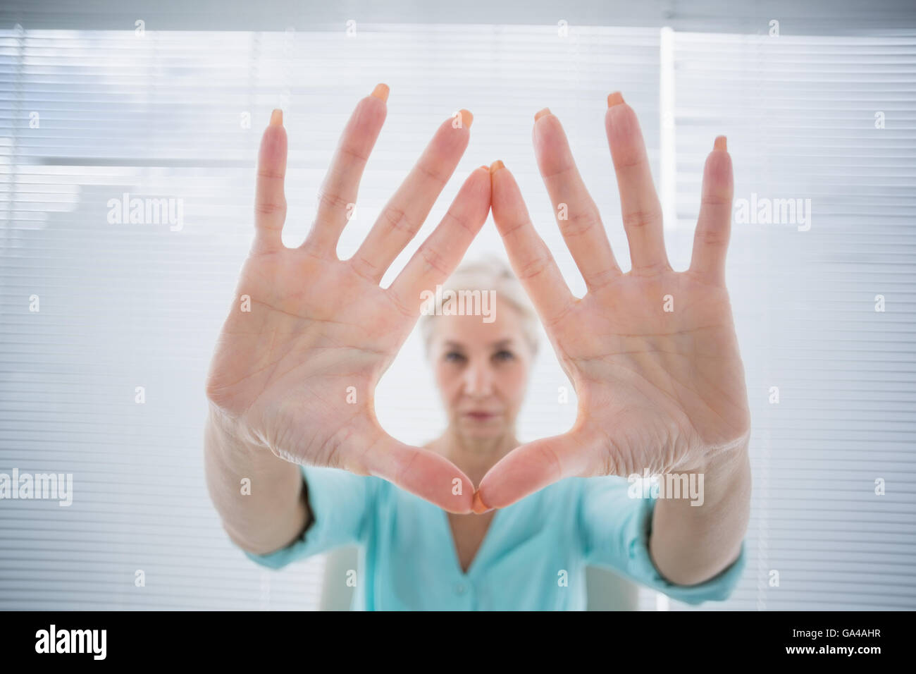 Senior woman with hands on glass Stock Photo - Alamy
